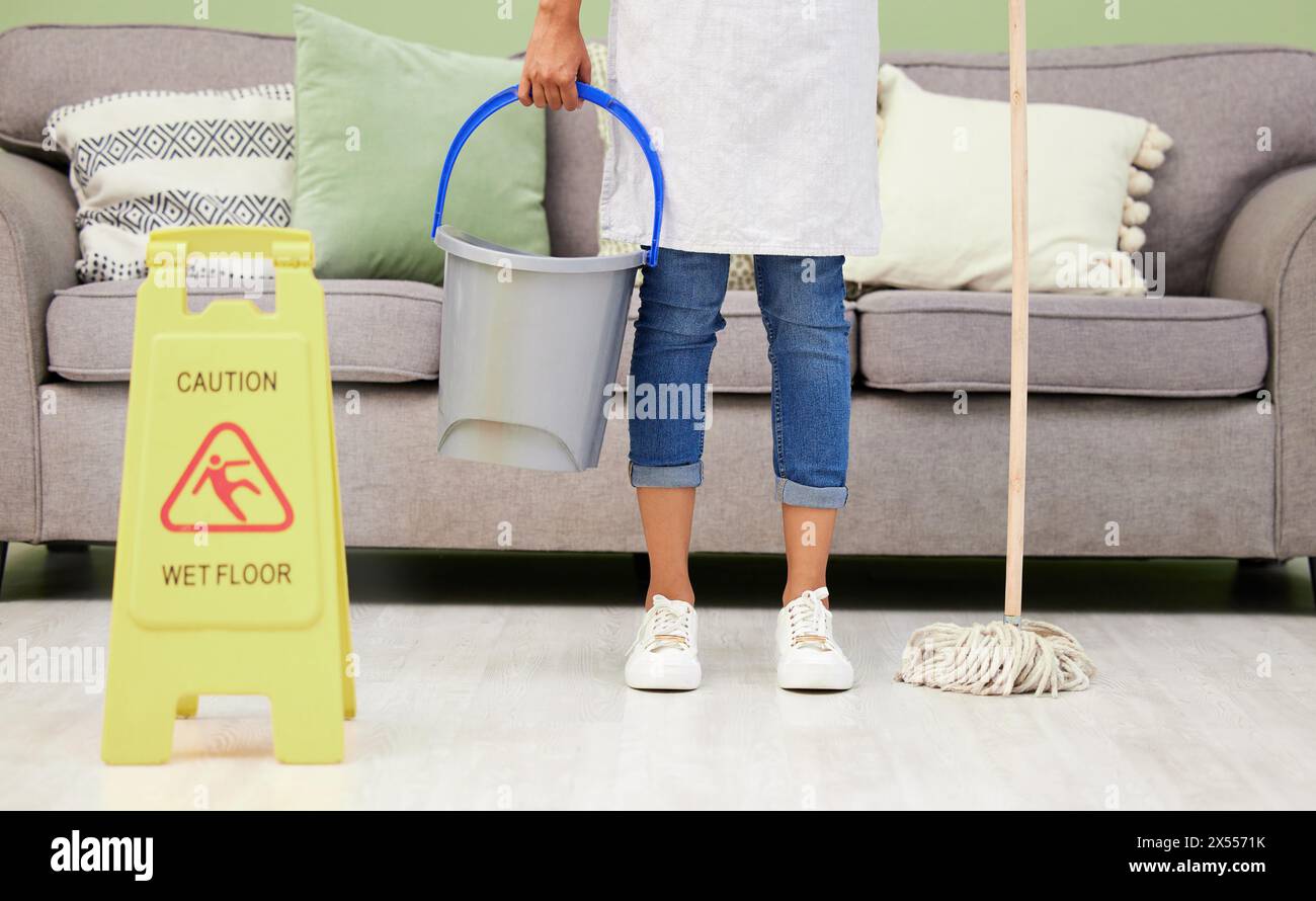 Woman, cleaning and caution sign for wet floor, slippery and ...