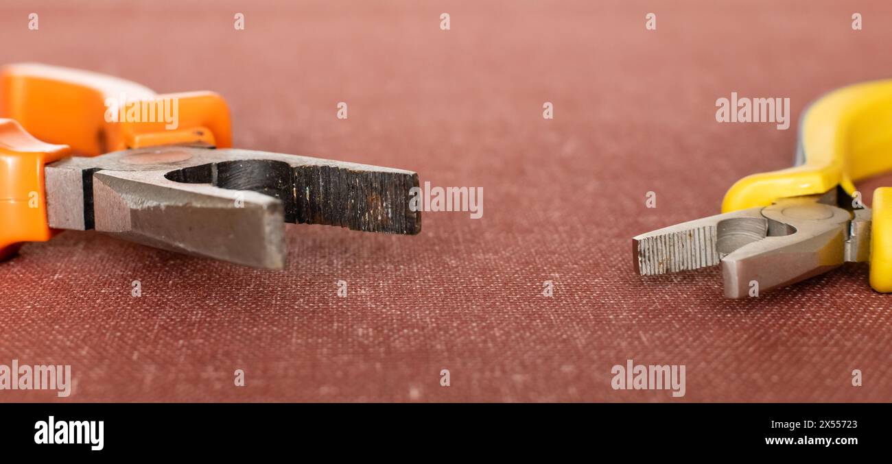 Set of wire cutters of different sizes close-up on workbench background ...