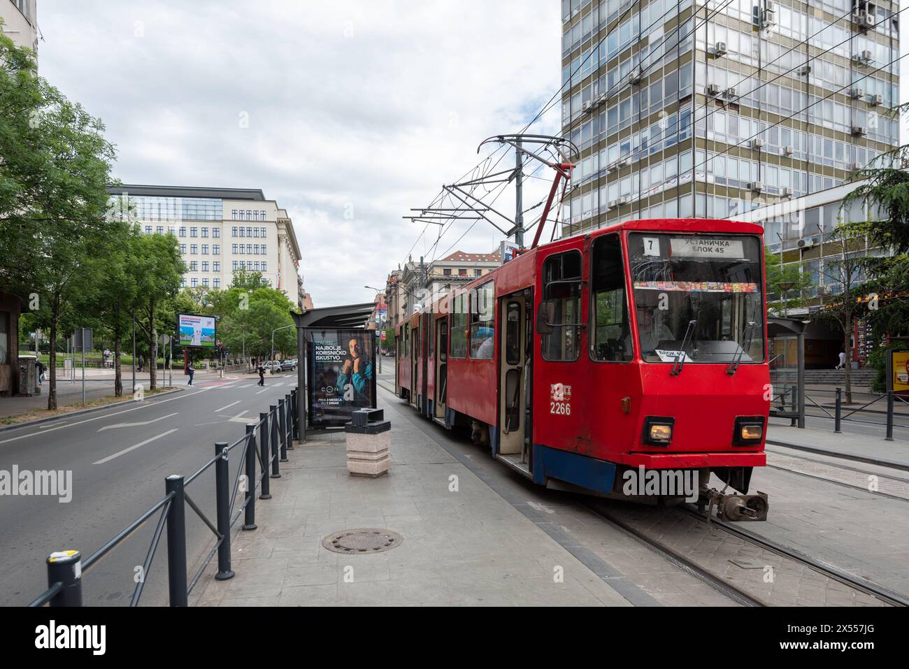 Traditional red electric trams taking passengers around the streets of ...