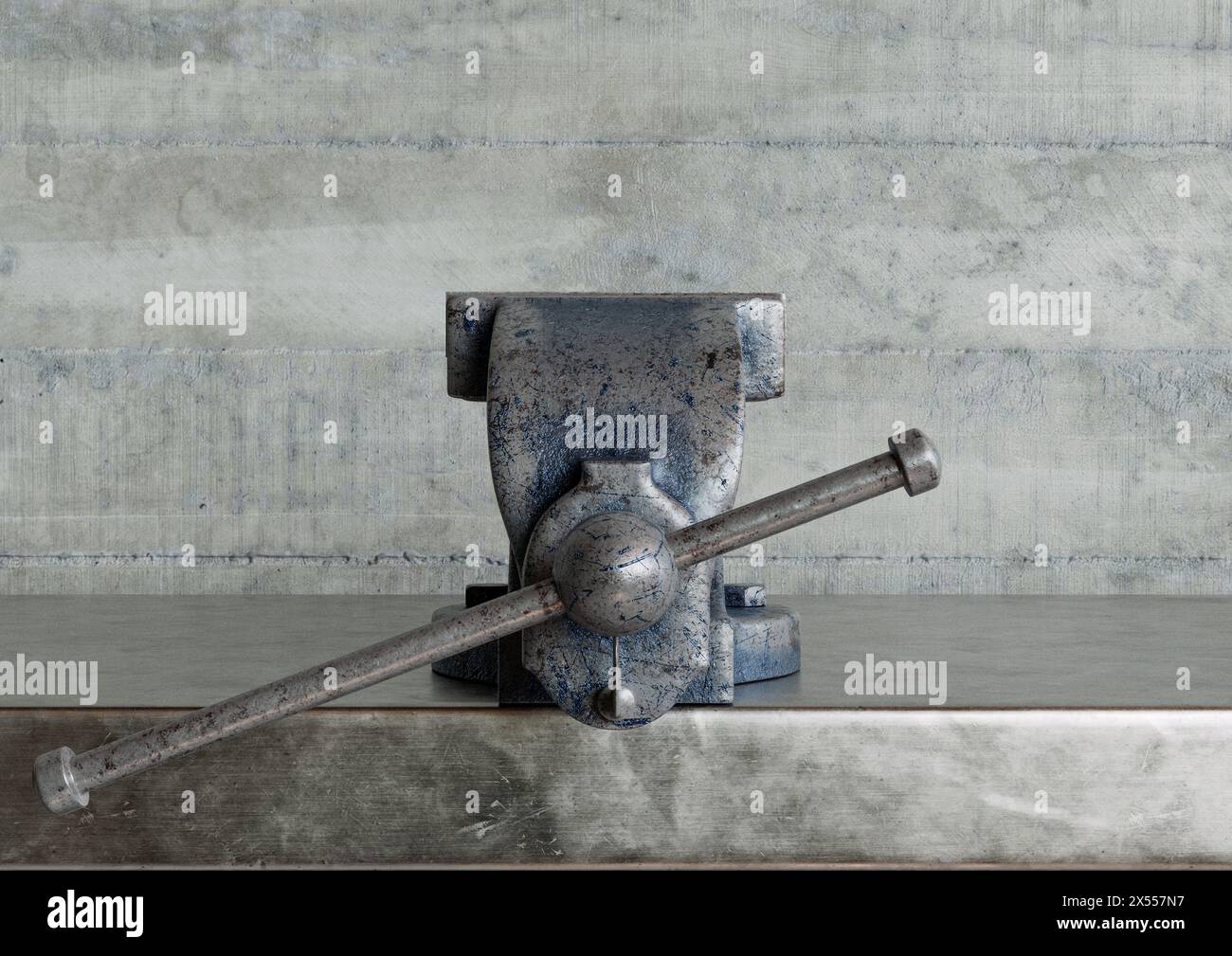 An industrial cast iron bench vice grip mounted on a metal workbench ...