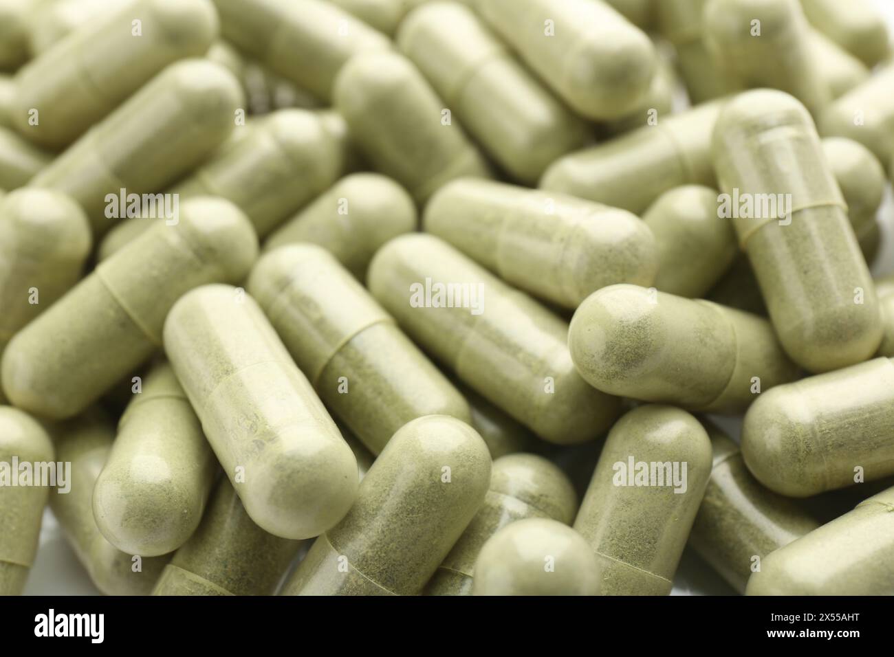 Light green vitamin capsules as background, closeup Stock Photo - Alamy