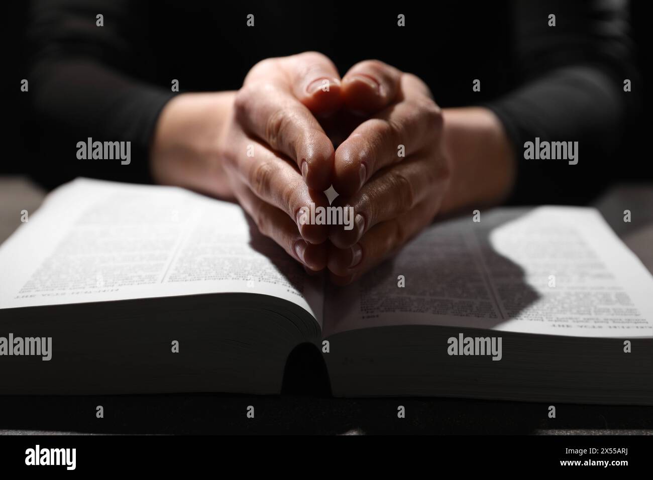 Religion. Christian woman praying over Bible at table, closeup Stock ...
