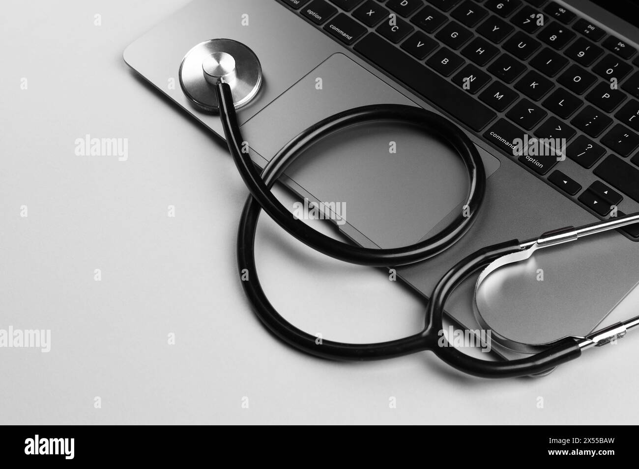 Laptop and stethoscope on light grey background. Space for text Stock ...