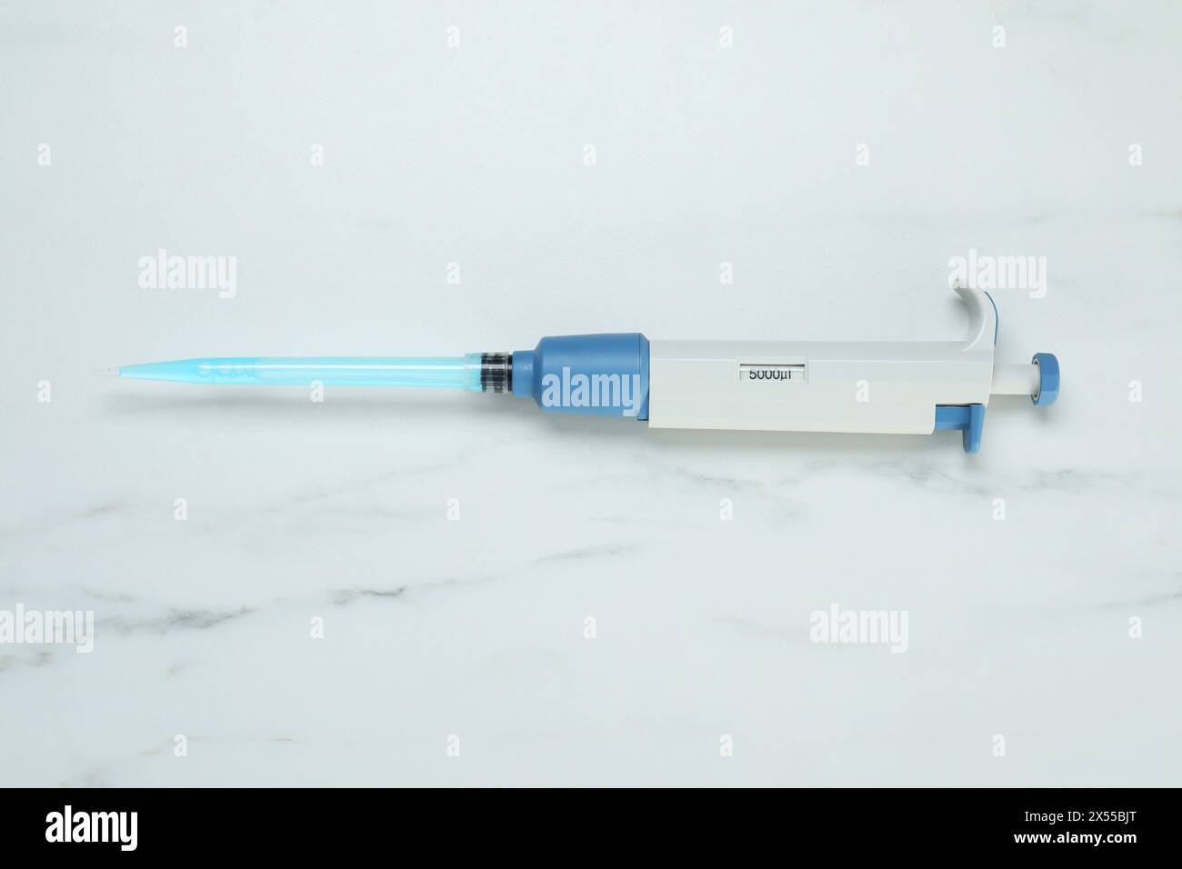 Laboratory analysis. Micropipette with liquid on white marble table ...