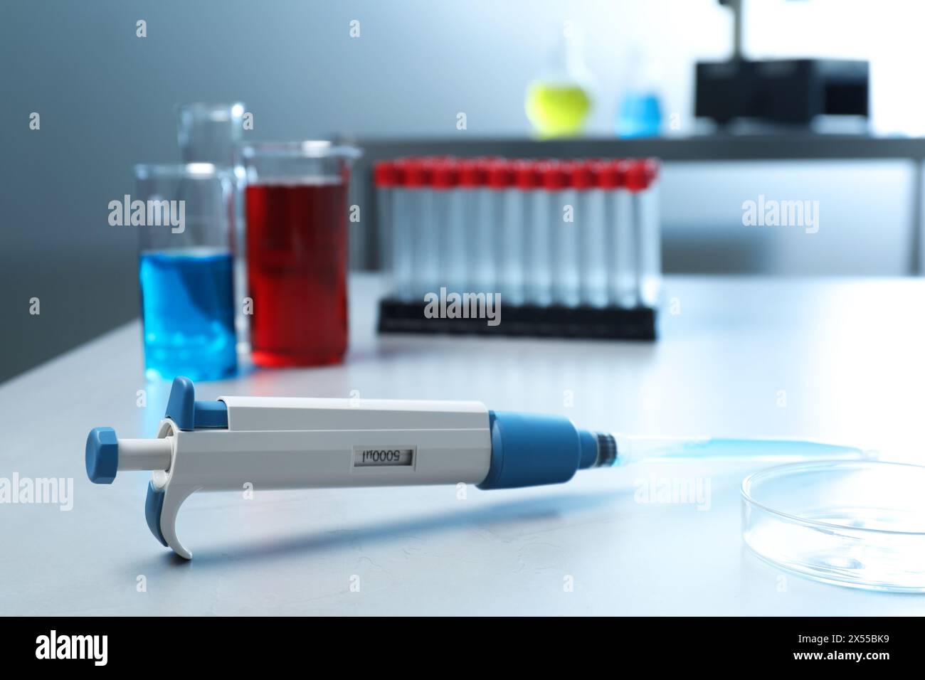 Laboratory analysis. Micropipette, petri dish, beakers with liquids and ...