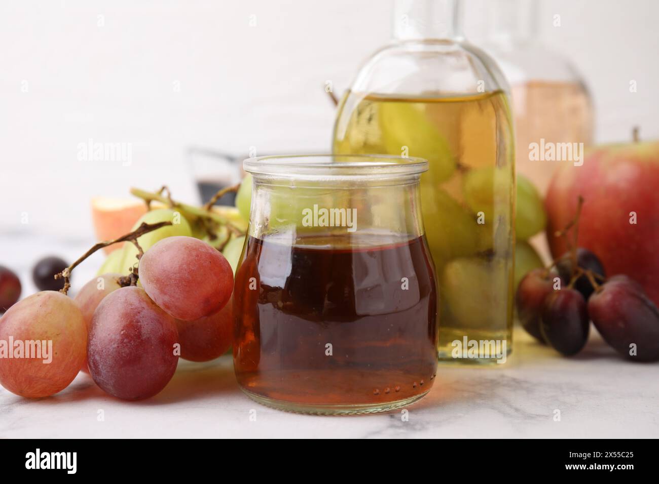 Different types of vinegar and ingredients on light marble table ...