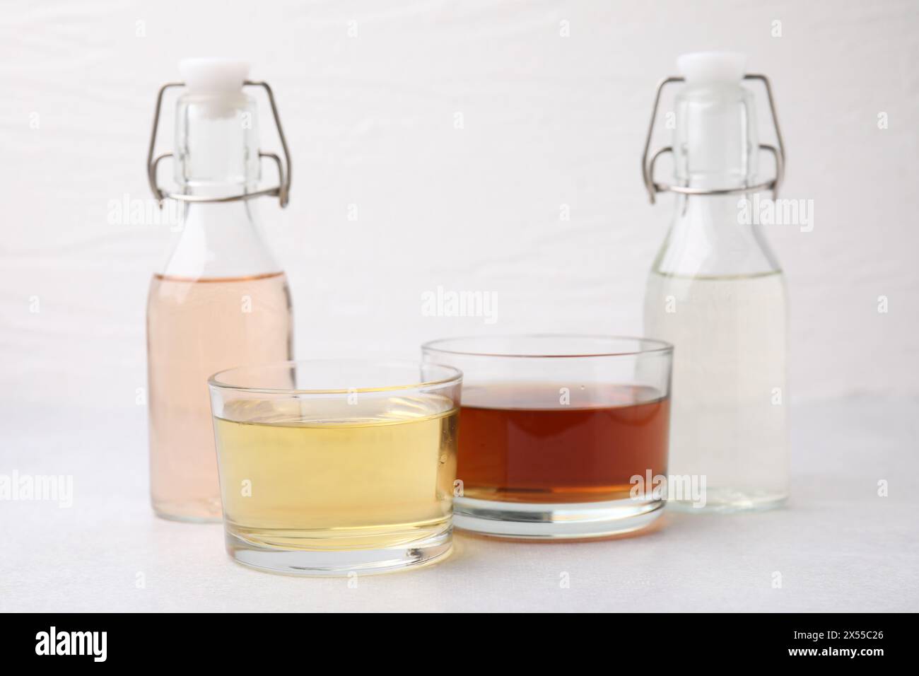 Different types of vinegar on light table, closeup Stock Photo - Alamy