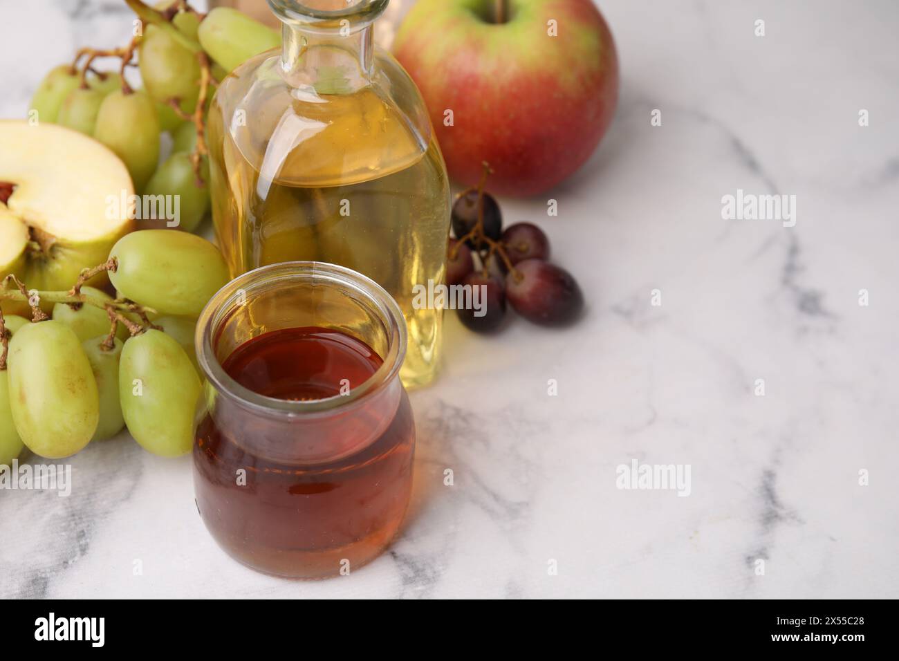 Different types of vinegar and ingredients on light marble table ...