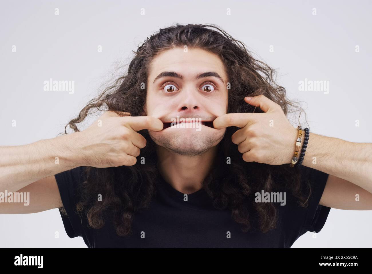 Man, portrait and crazy face in studio for emoji, comedy and comedy by ...