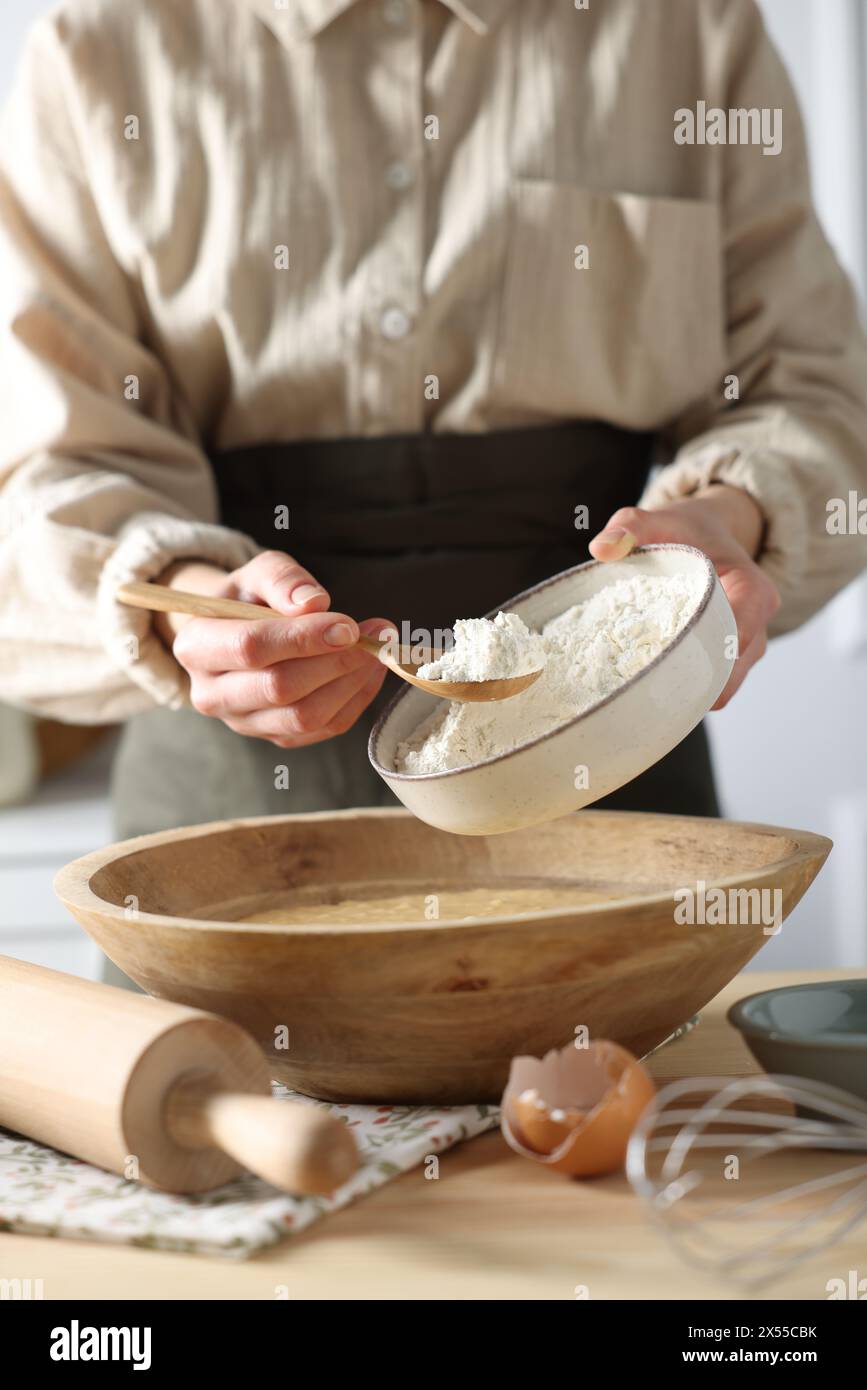Woman adding flour dough in hi-res stock photography and images - Alamy