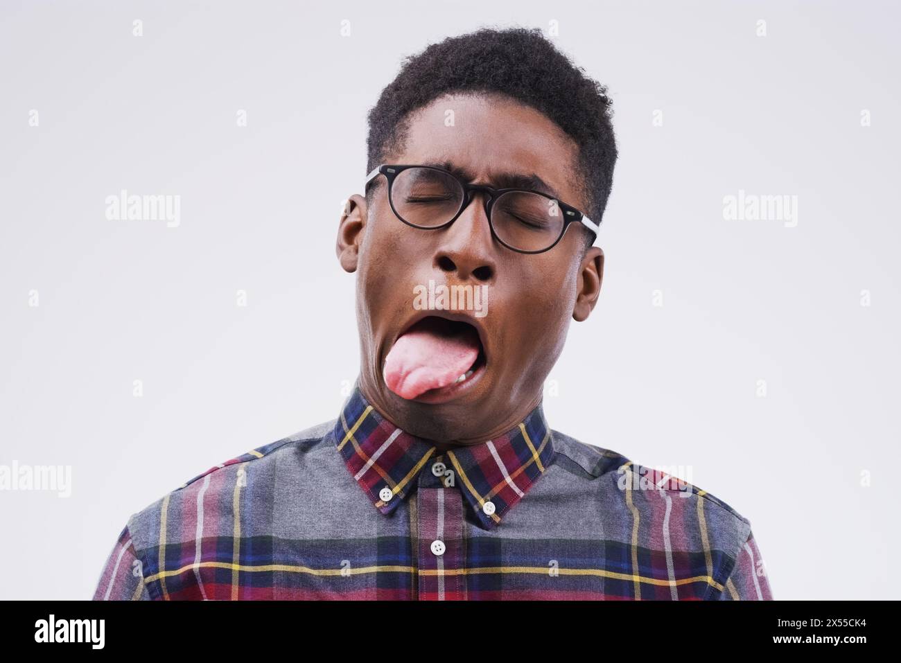 Man, crazy and tongue out in studio for emoji, comedy and fun by white ...