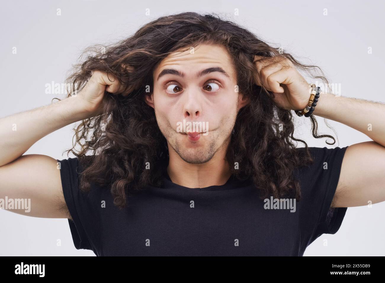 Gen z man, crazy and funny in studio for face, emoji and ear pull by ...