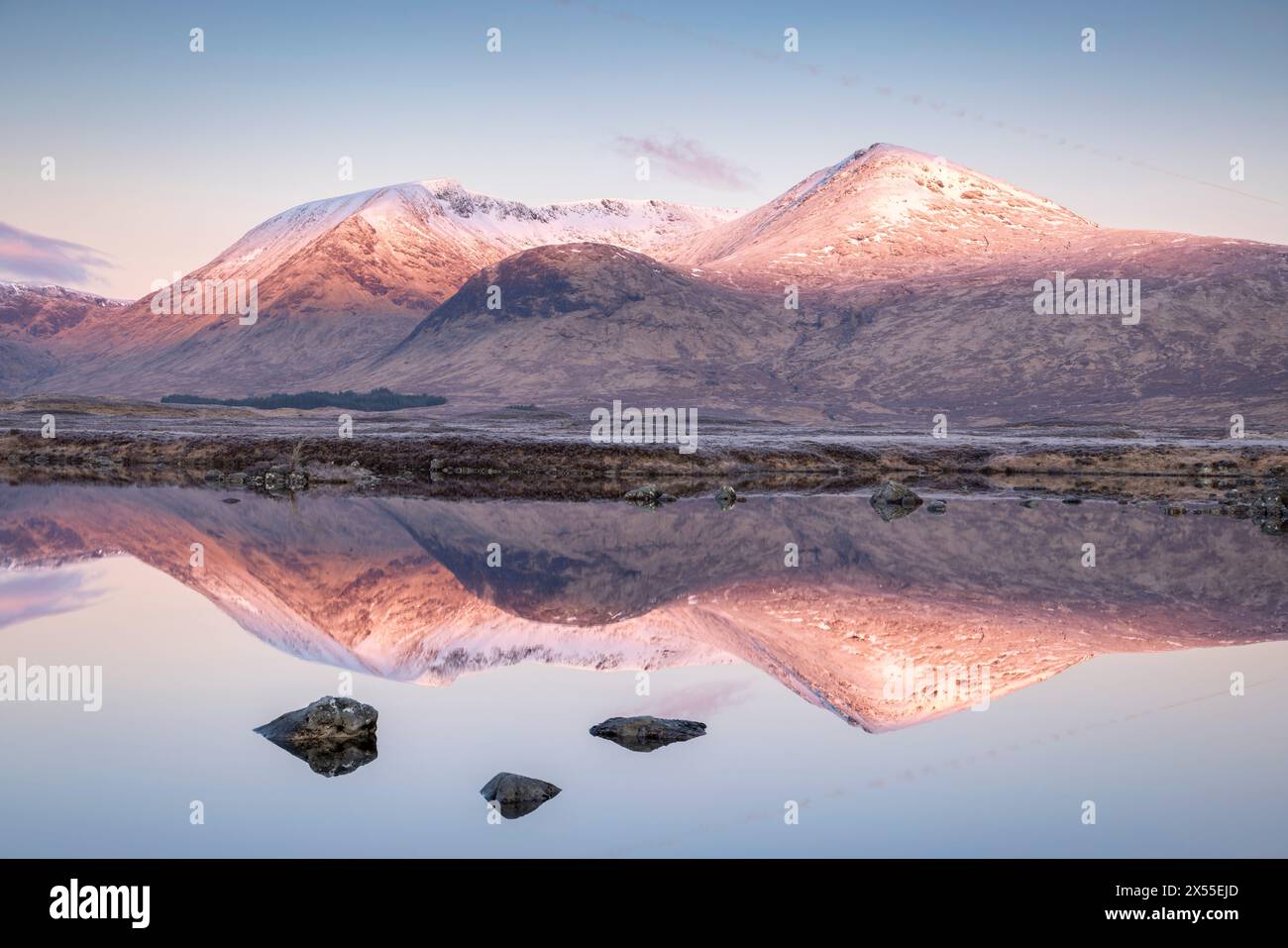 Dawn light on snow dusted Black Mount, reflected in Lochan na h ...