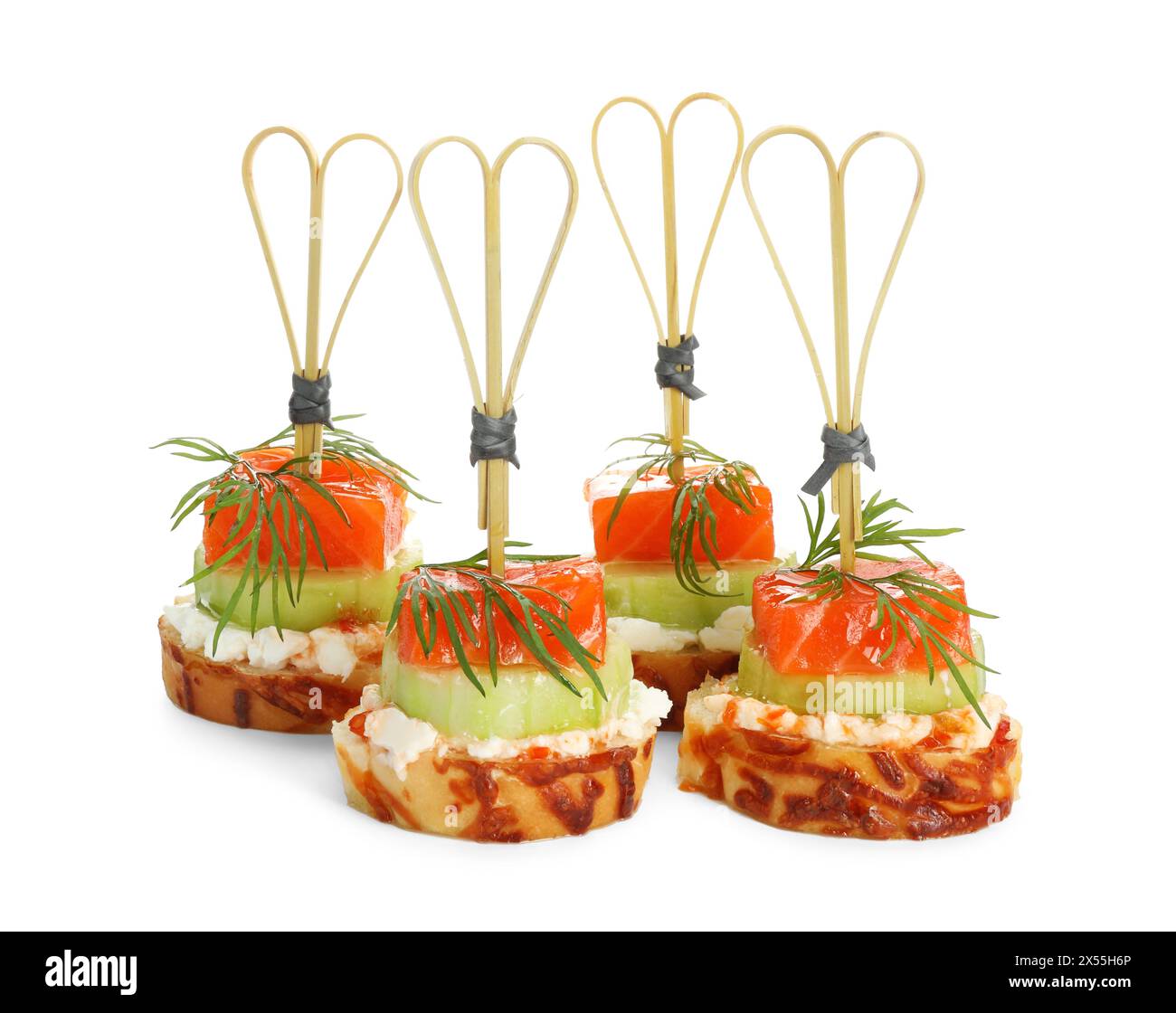 Tasty canapes with salmon, cucumber, bread and cream cheese isolated on ...