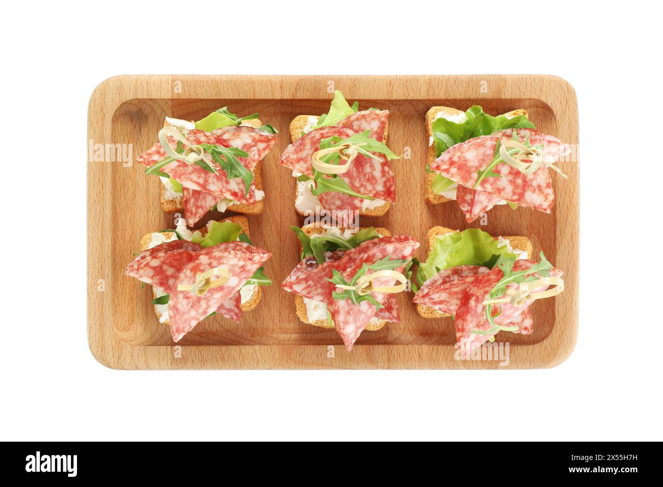 Tasty canapes with salami, greens and cream cheese isolated on white ...