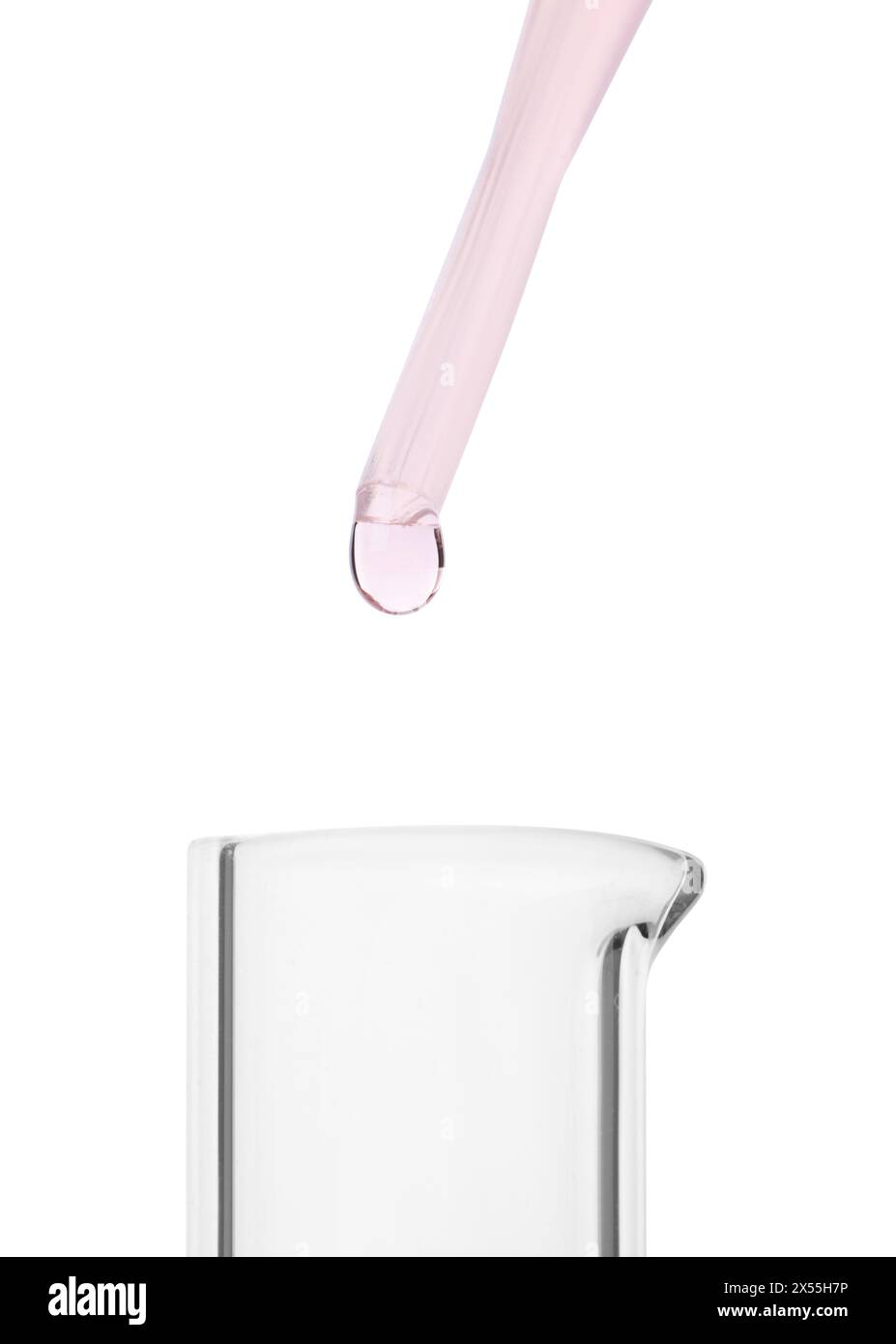 Dripping liquid from pipette into beaker on white background, closeup ...