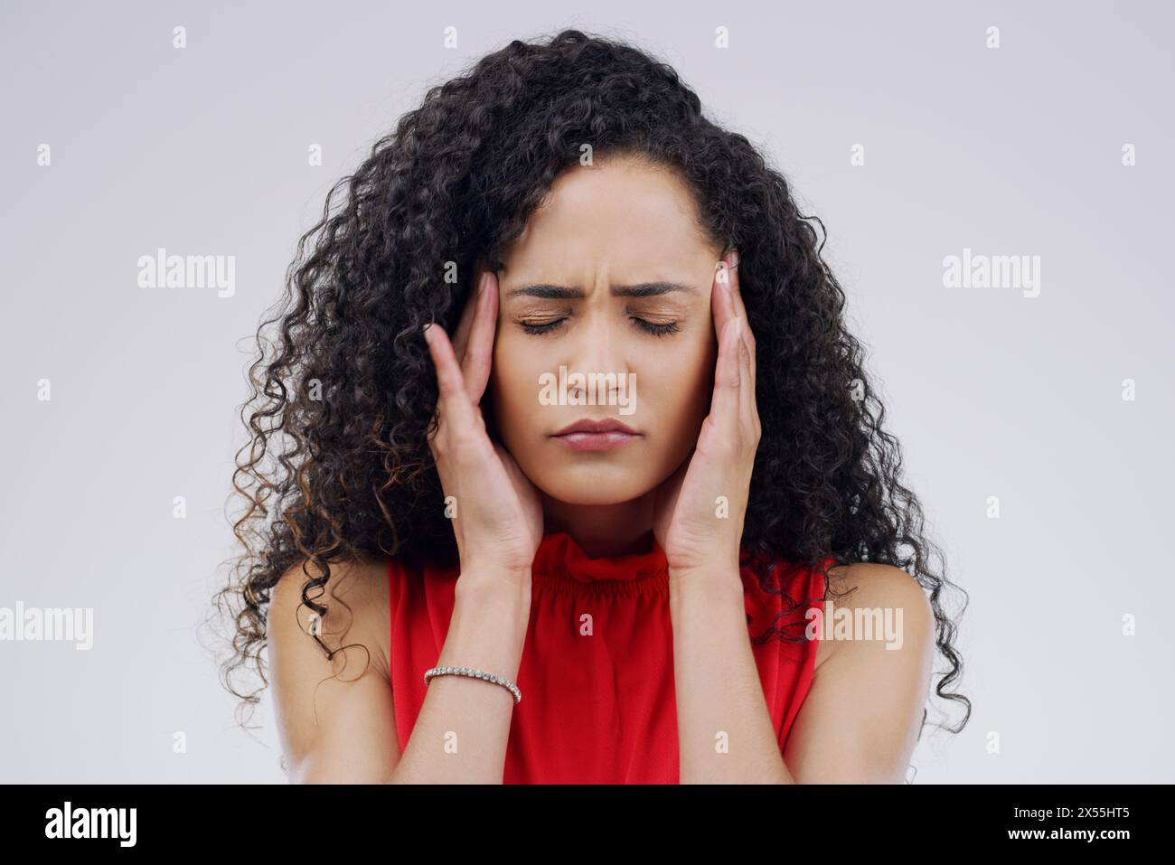 Woman, hands and headache or temple pain in studio with pressure or ...