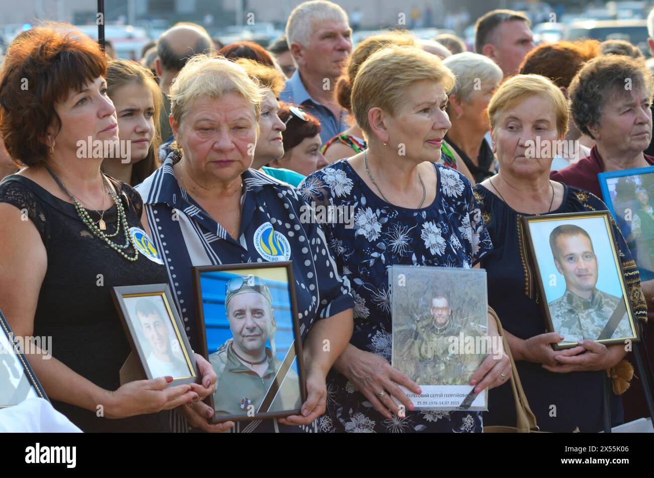 Mourning women mothers and wives crying and holding a portraits of ...