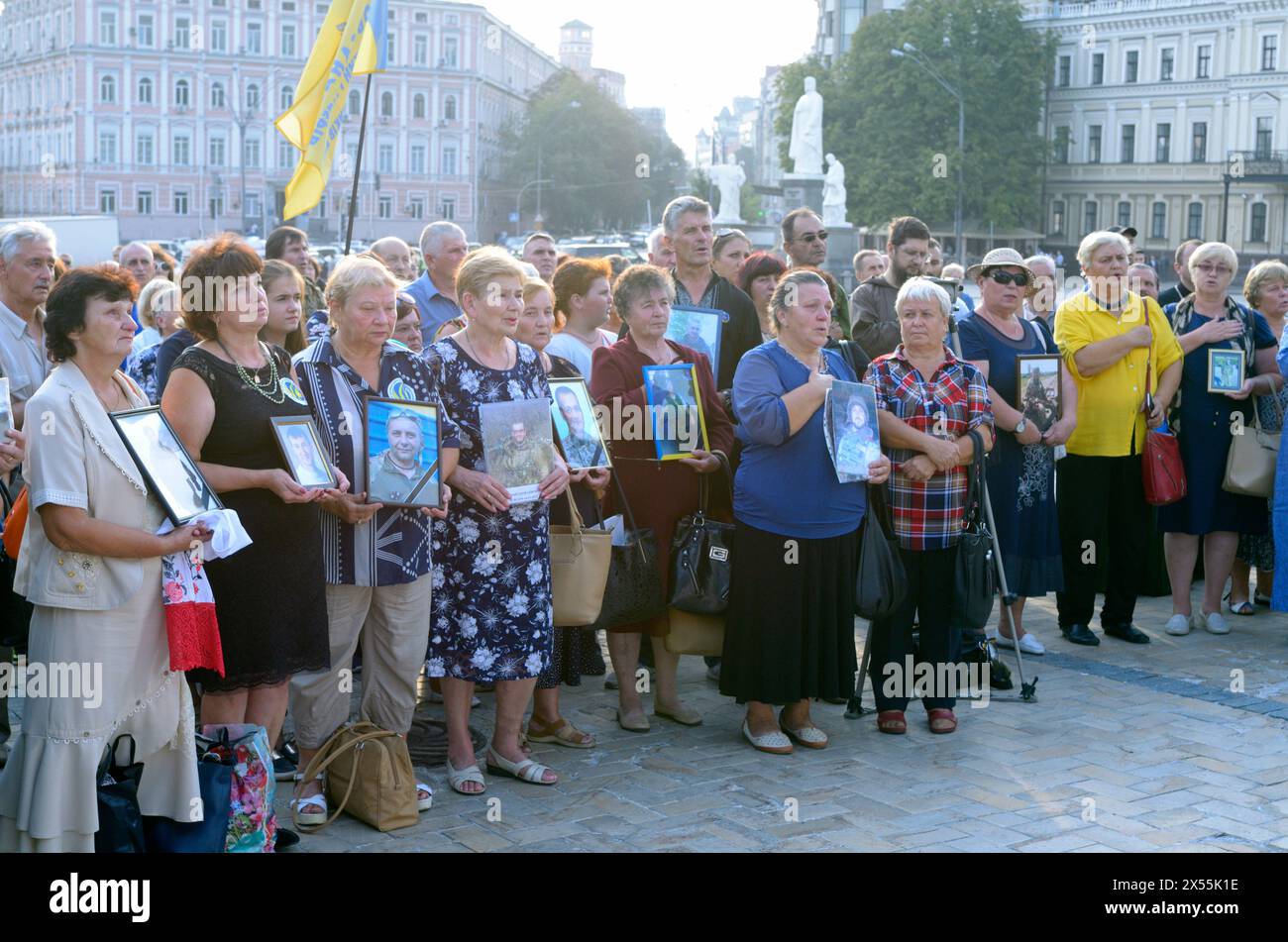 Mourning women mothers and wives crying and holding a portraits of ...