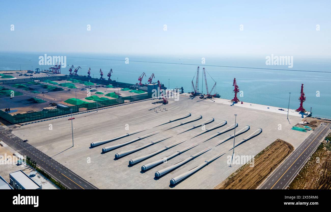 Expansive Seaport Terminal With Stacked Wind turbine blades Cargo and ...