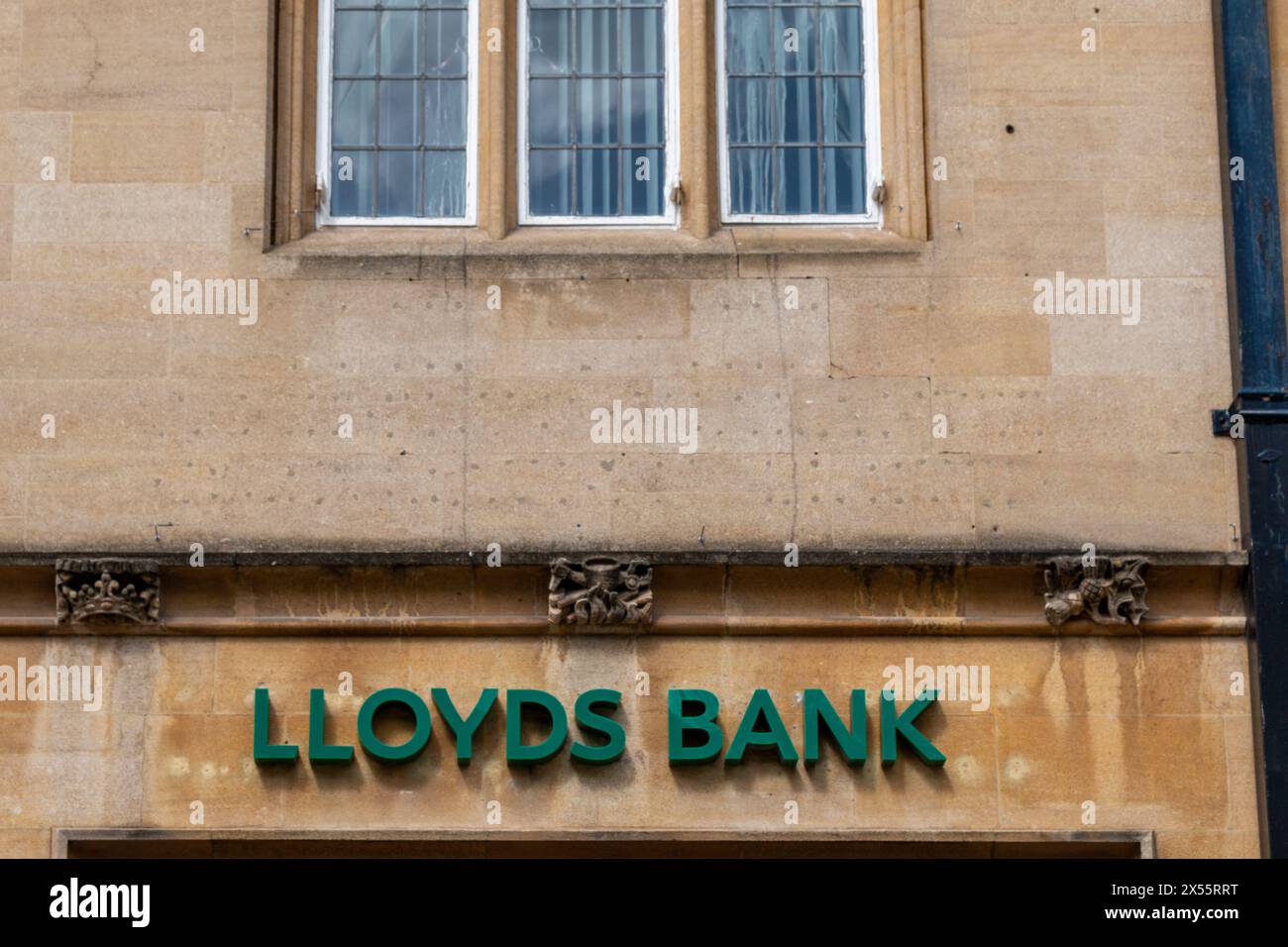 A modern Lloyds Bank sign on an old stone building, Sydney Street ...