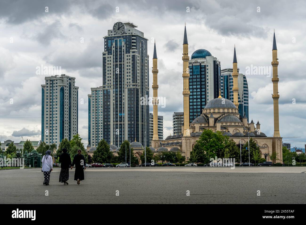 The women walk toward Grozny City skyscrapers and the "Heart of ...