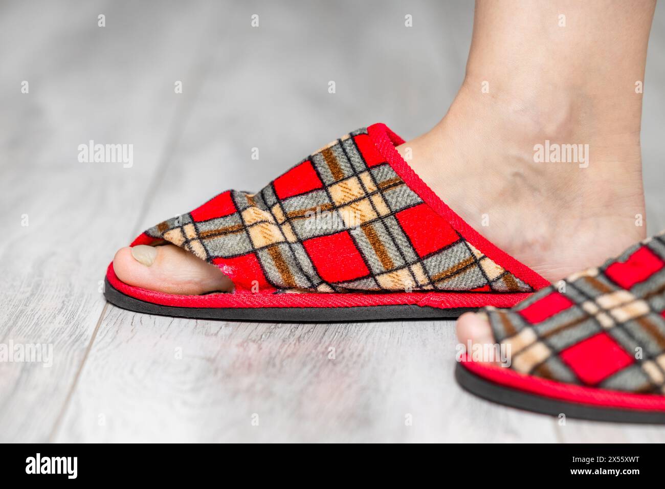 foot shod in an old leaky slipper. old slipper. holey sneaker. the toe ...