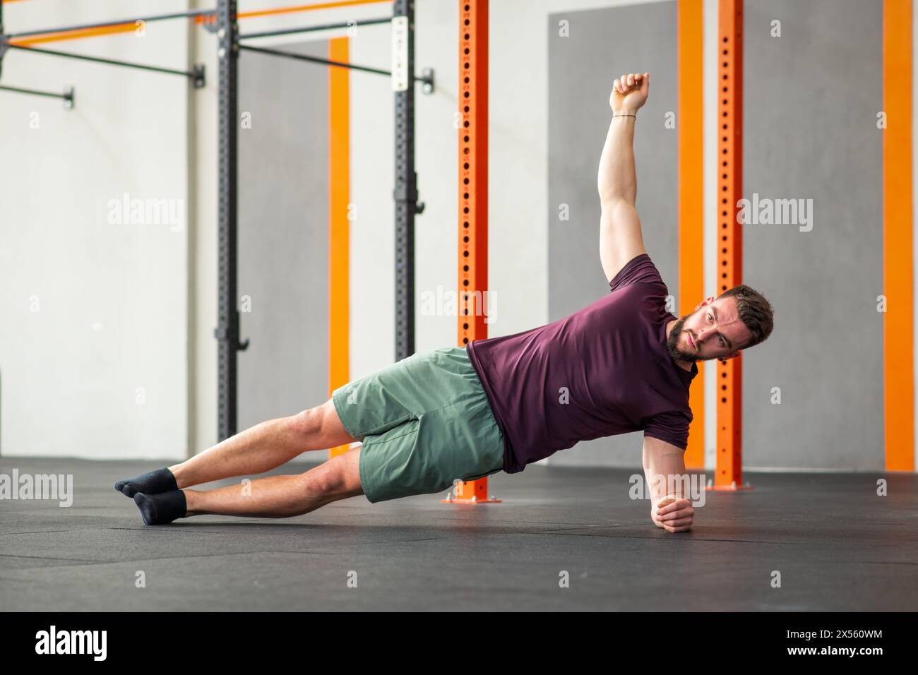 Flexible strong male performing side plank calisthenics exercise on ...