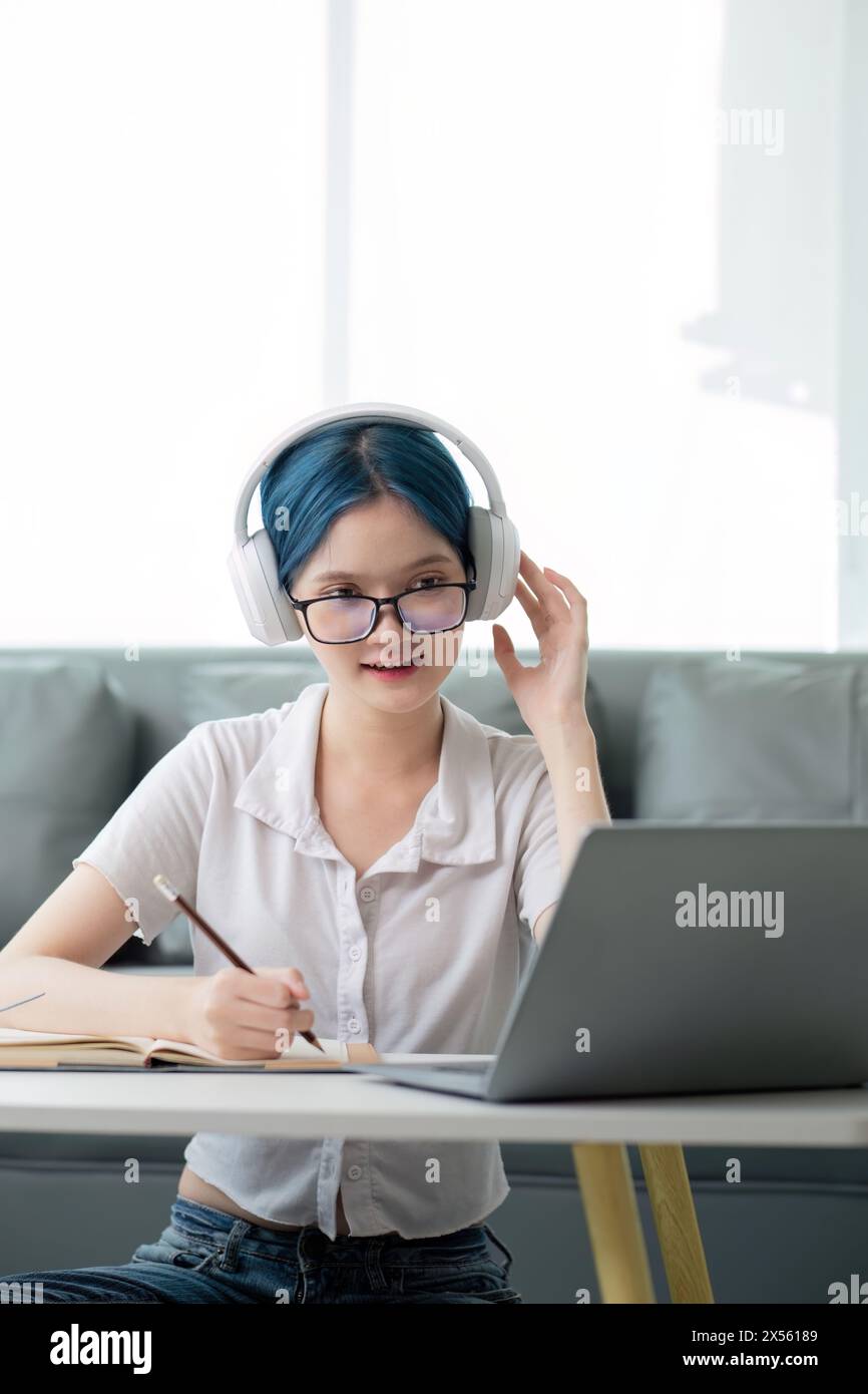 Smiling girl student wear headphone study online with teacher, happy ...