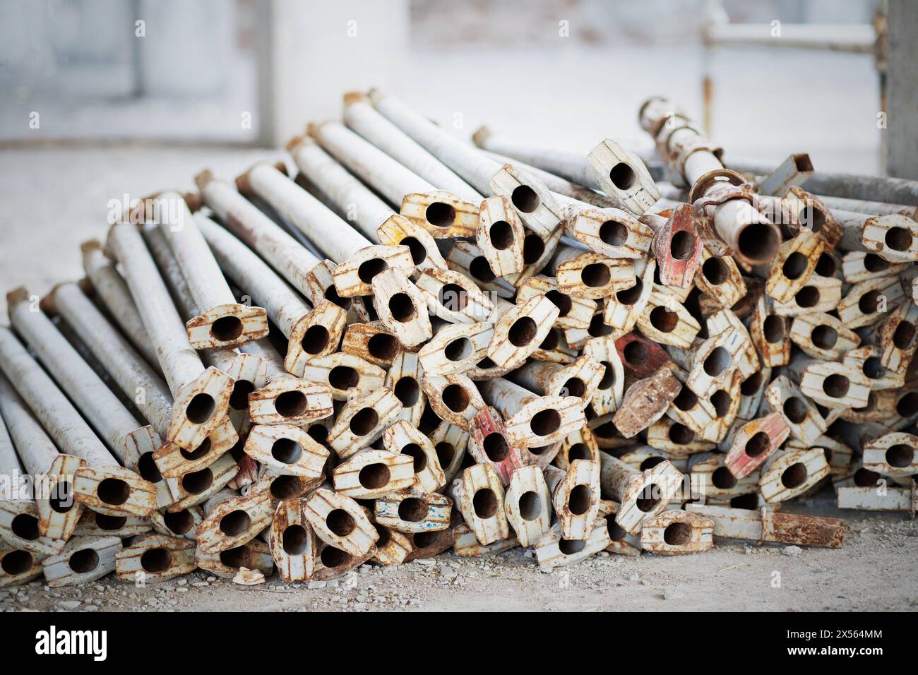 Racks of scaffolding in disassembled form lie on the construction site ...
