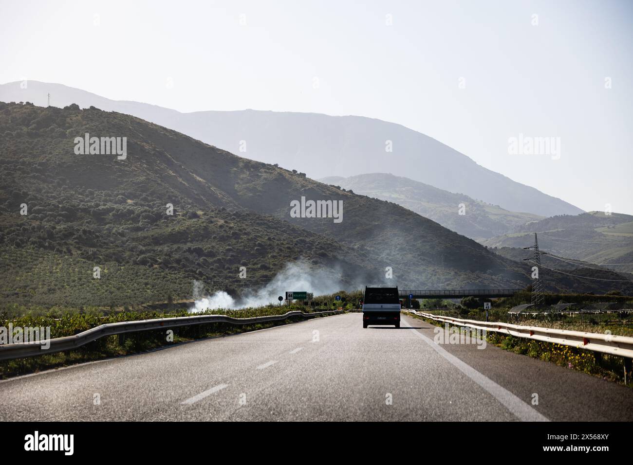 a fire burning on the side of a motorway on sicily, Italy, April 2024 ...