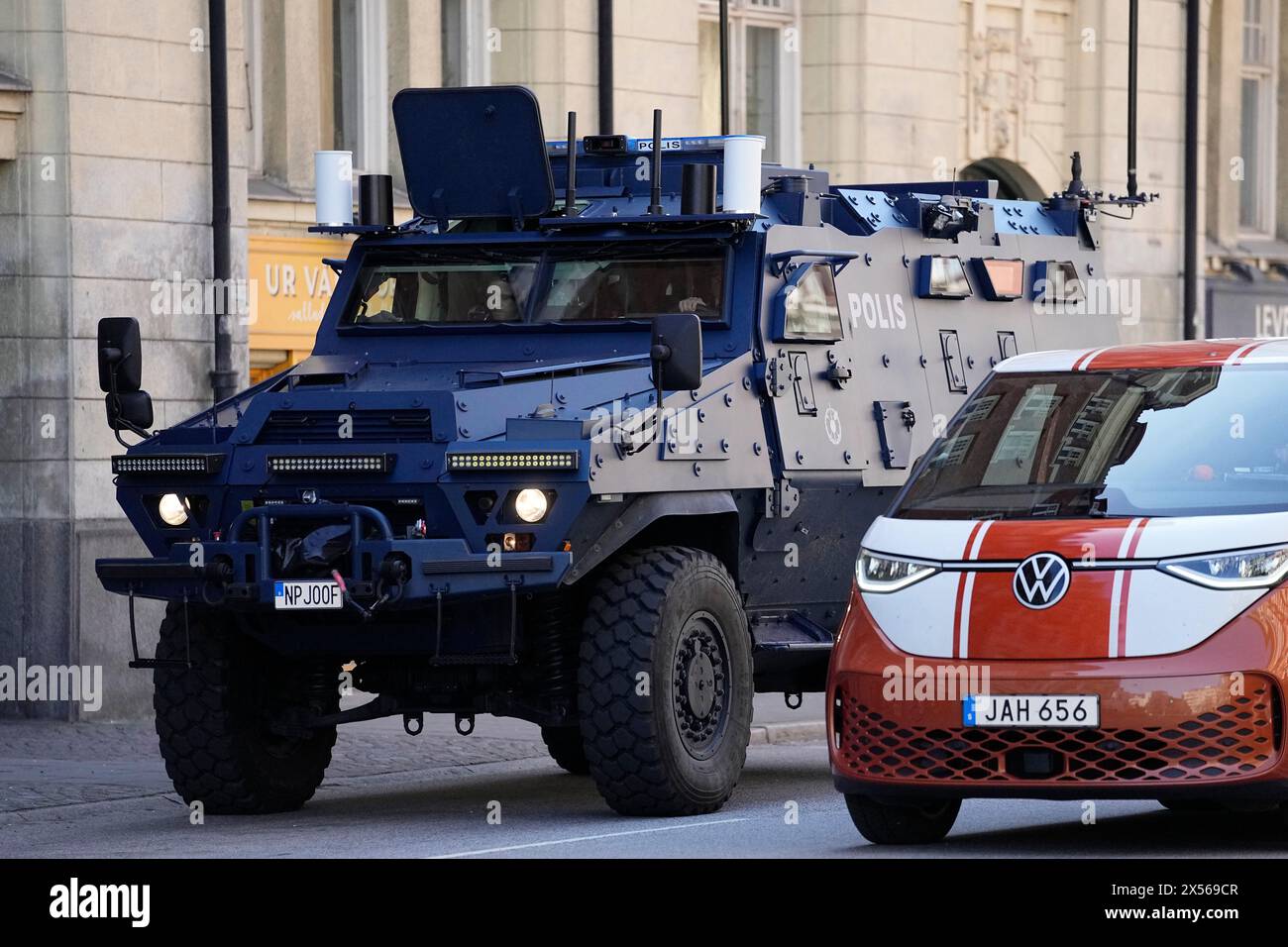An armored police vehicle drives in the city center ahead of the first ...
