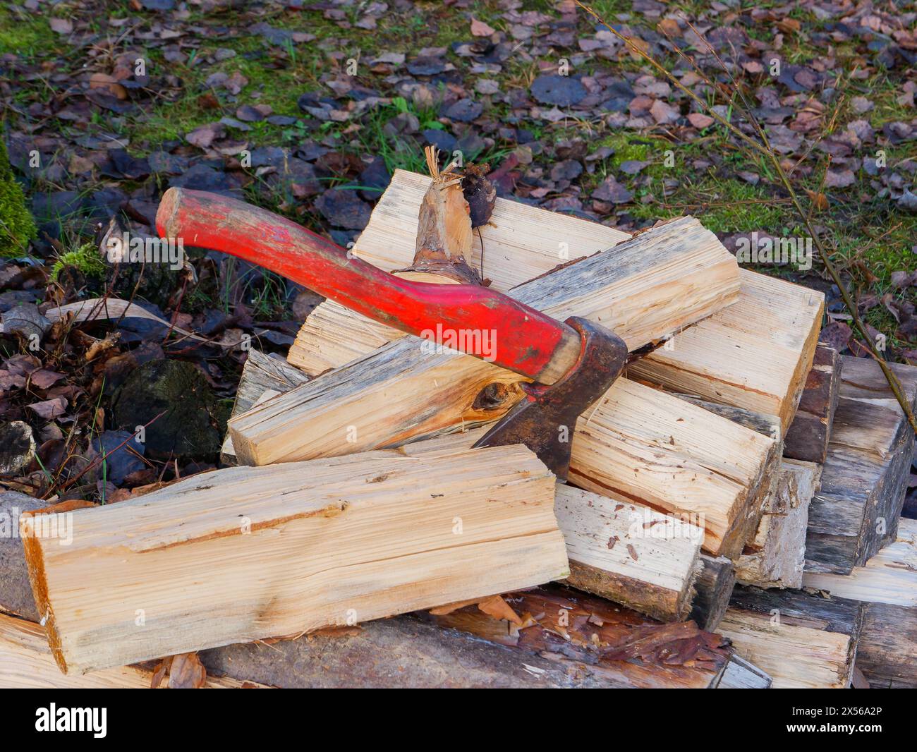 Red Handled Axe lies on freshly cut firewood, close-up Stock Photo - Alamy