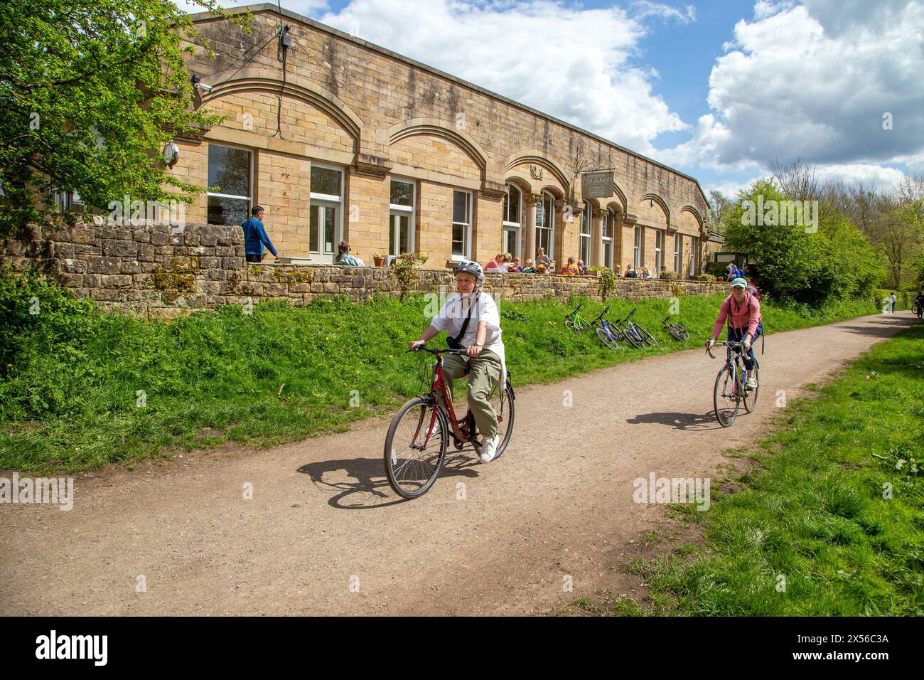 People cycling past Hassop Station Cafe while riding along the Monsal ...