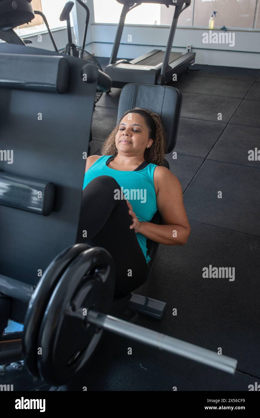 Sporty woman exercising on multistation at gym . Fitness exercising in ...