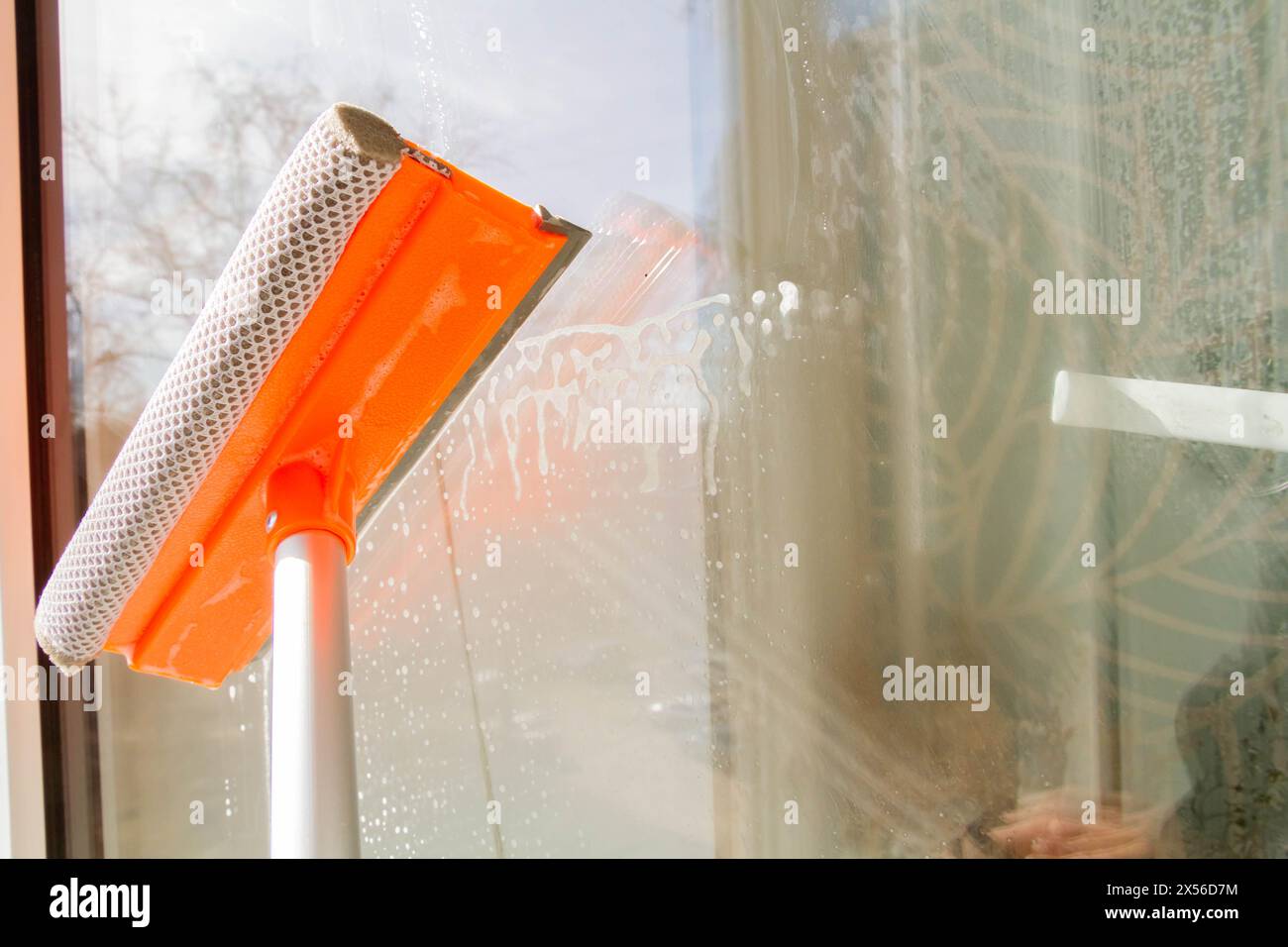 Window washing. Cleaning the window with a brush and foam. The concept of cleanliness and ...