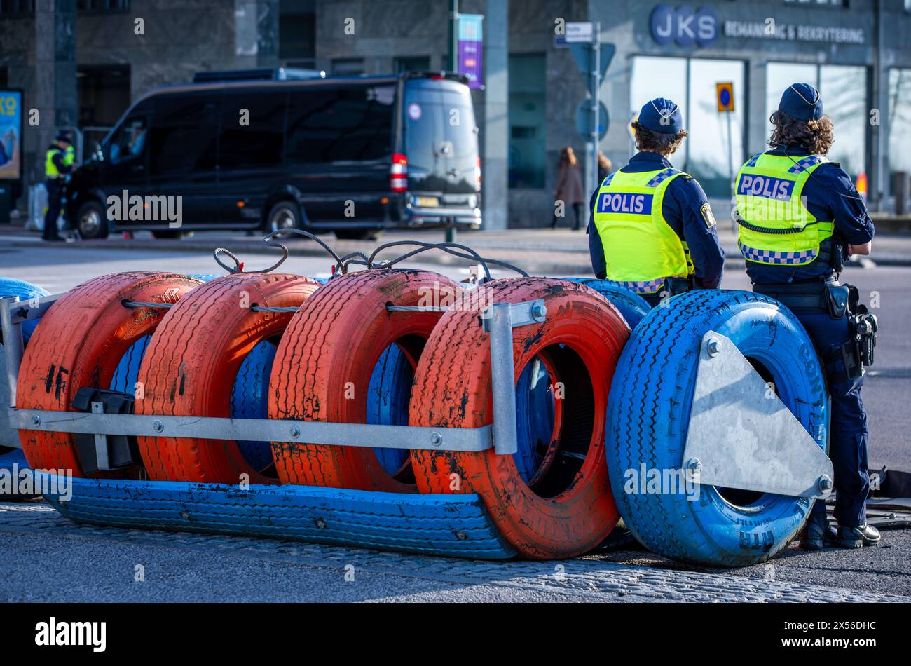 07 May 2024, Sweden, Malmö: Police officers lean against a mobile ...