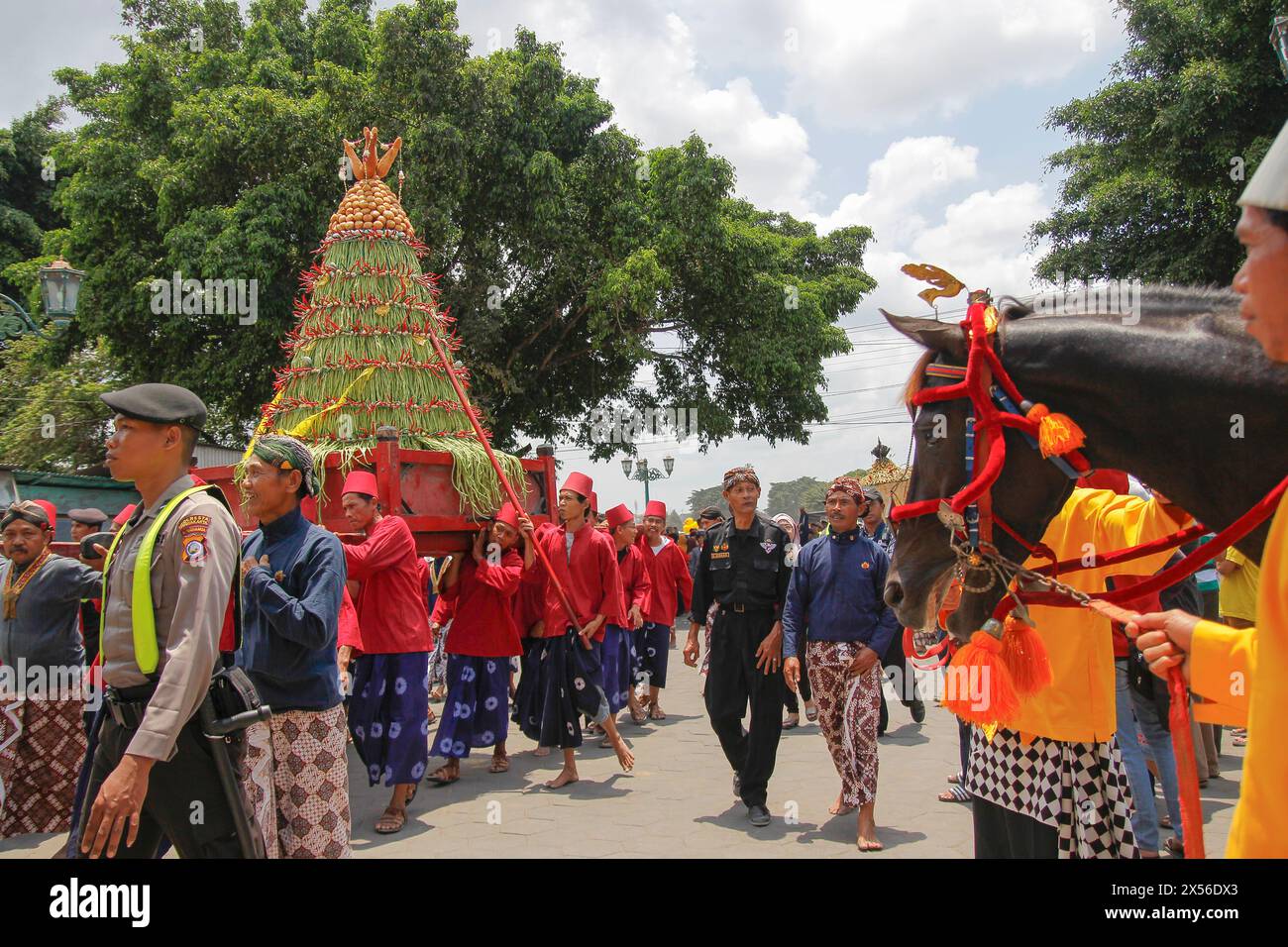 Abdi dalem carries Gunungan in the Great Grebeg tradition event ...