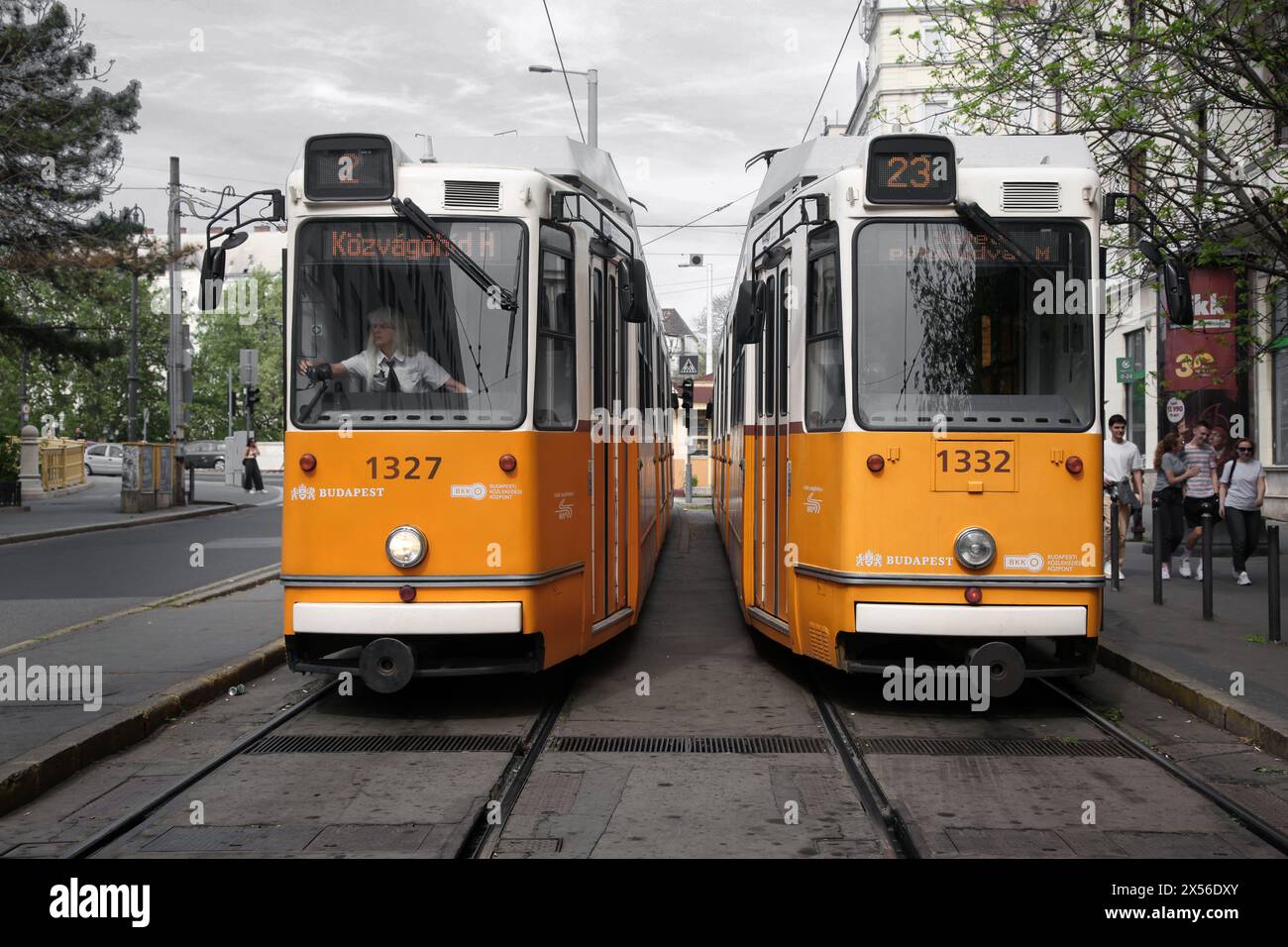 Two traditional yellow tram cars meet each other in Budapest, Hungary ...