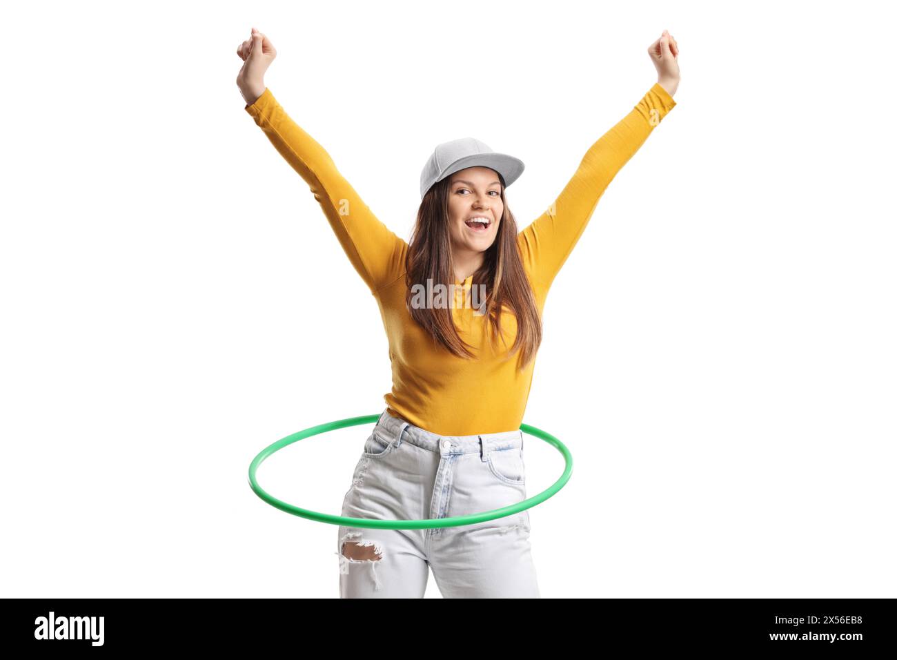 Happy young woman spinning a hula hoop and raising arms isolated on ...