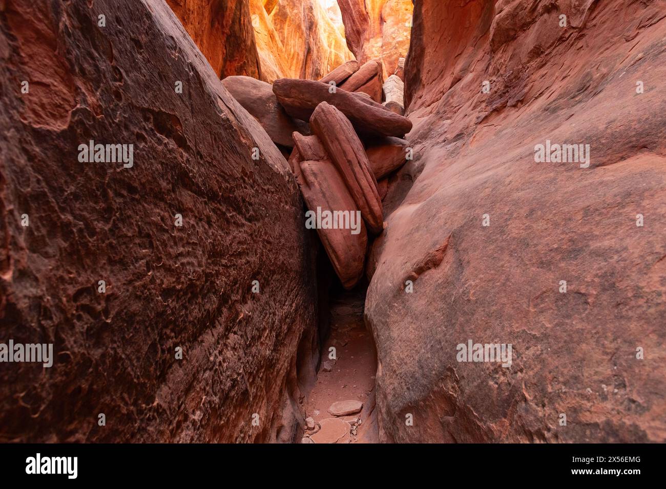Two large rocks face each other to create a slot canyon inside the ...
