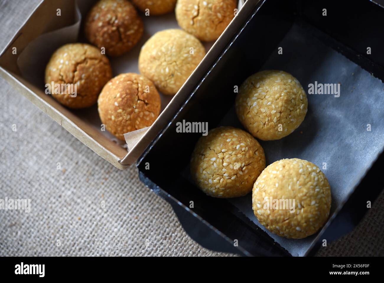 Sweet sesame cookies in cardboard boxes on burlap. Cookies in a box ...