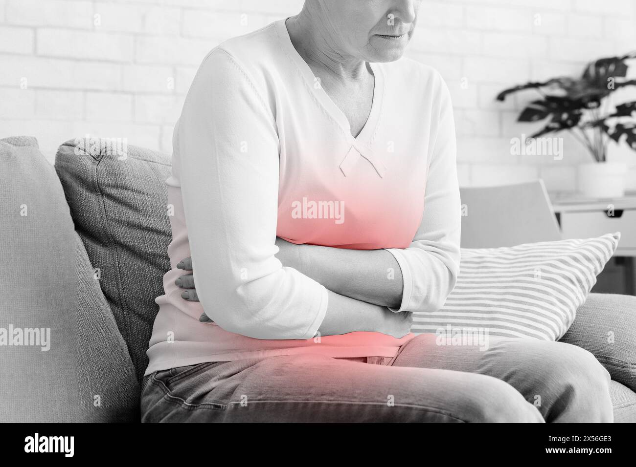 Sad senior woman holding her abdomen, suffering from stomach pain Stock ...