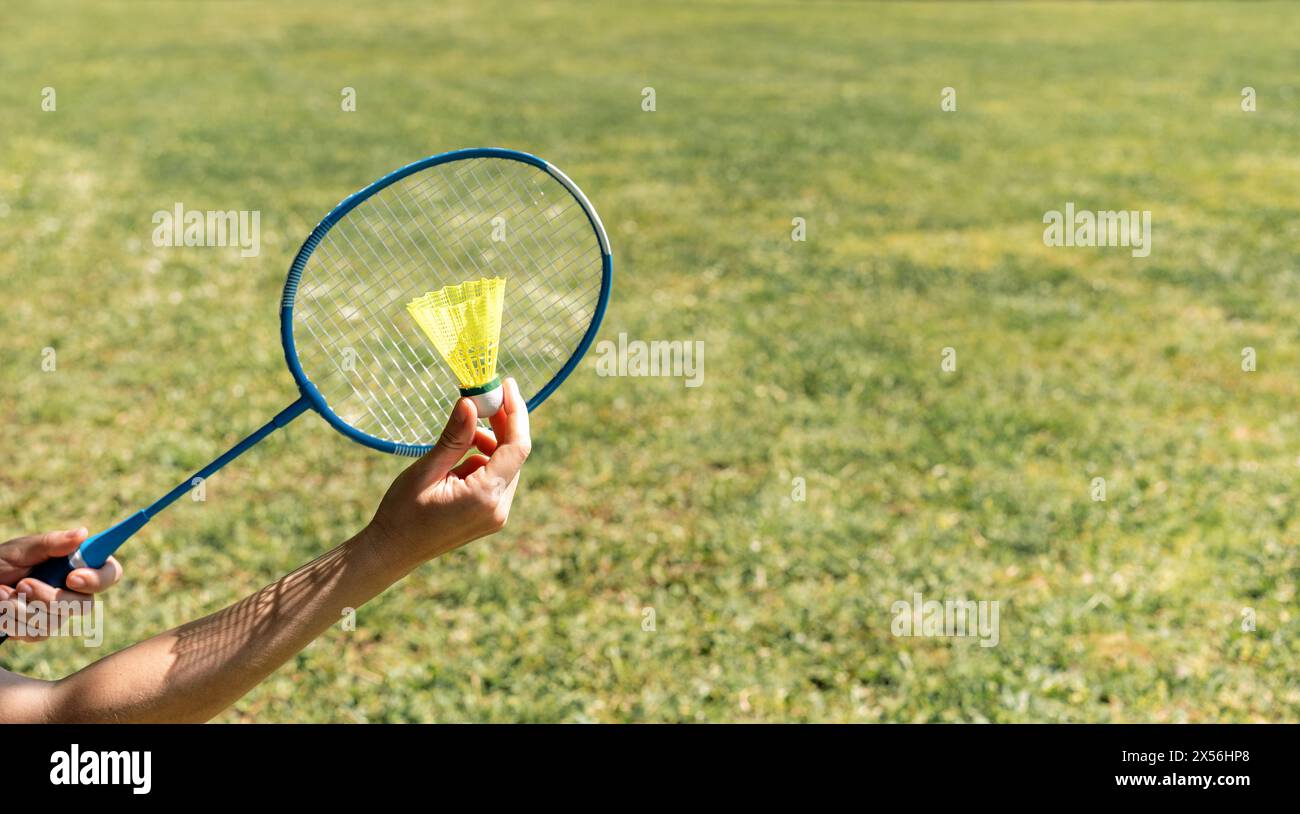People playing badminton in the park. Summer sports activity and ...