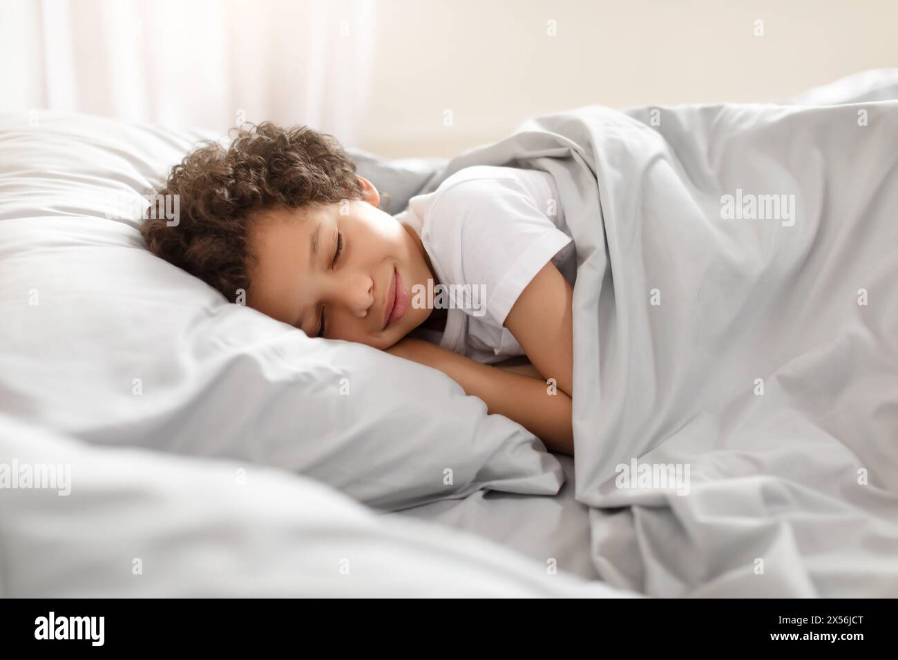 Young African American Boy Sleeping in Bed Stock Photo - Alamy