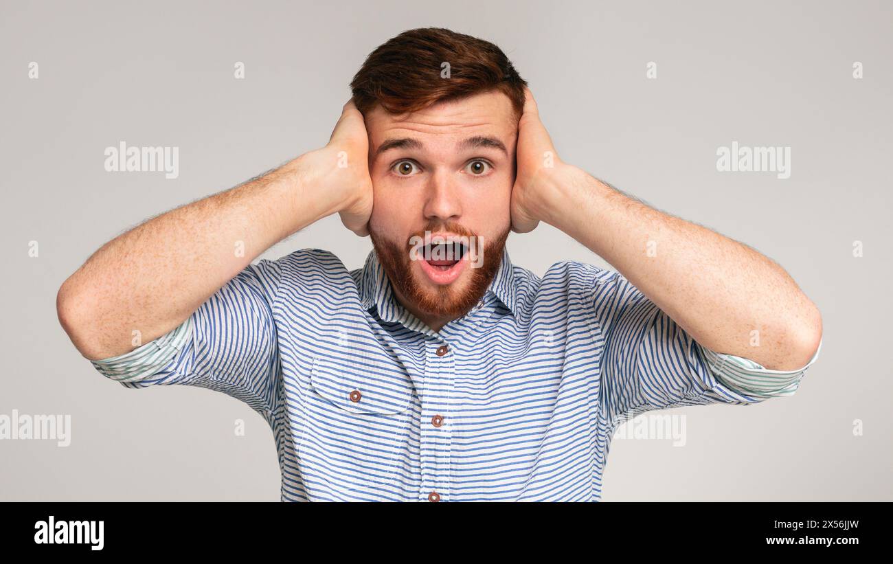 Portrait of irritated man shouting and covering his ears Stock Photo ...