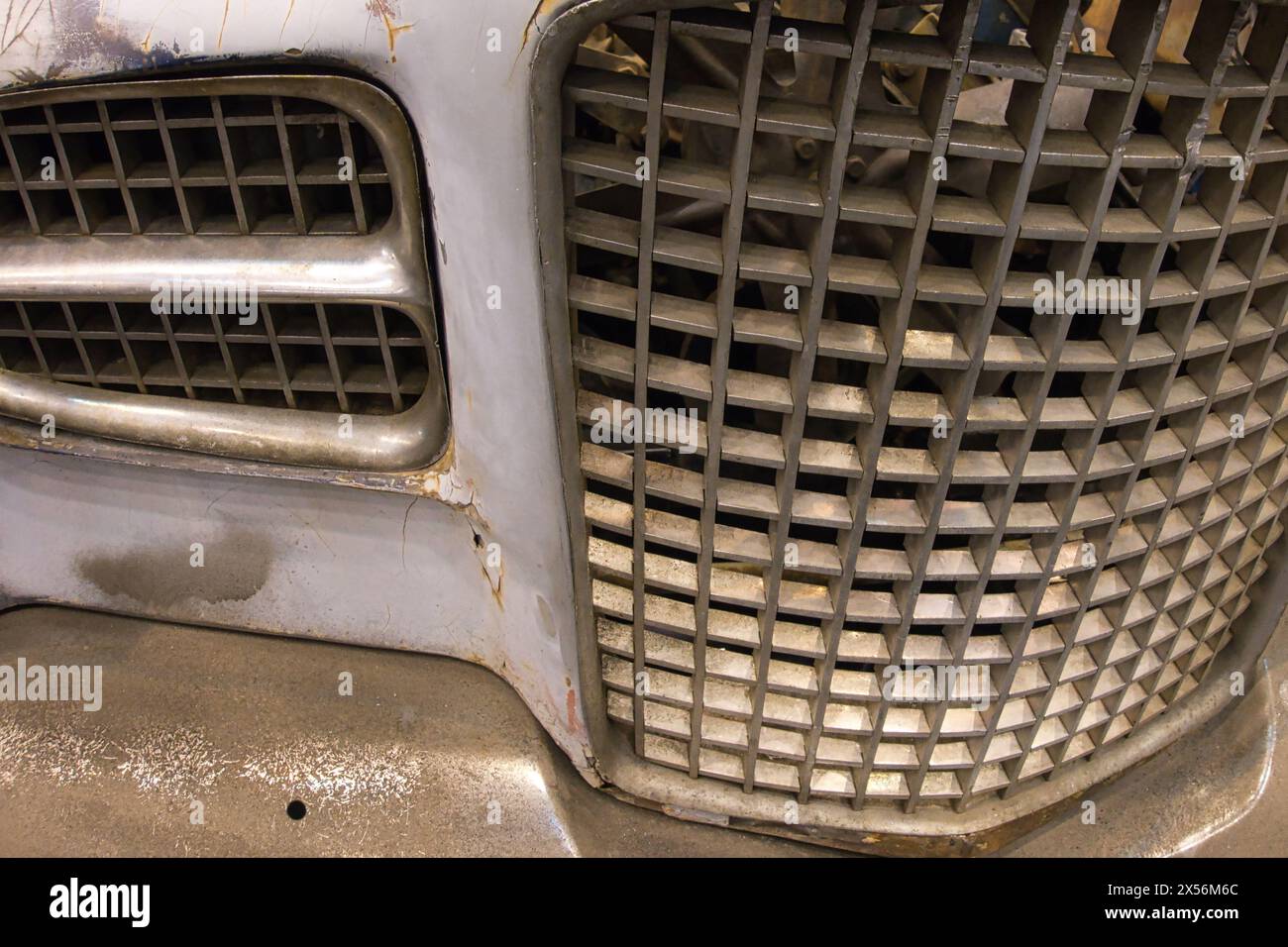An unrestored, rusty vintage sports car shows the charm of a classic ...