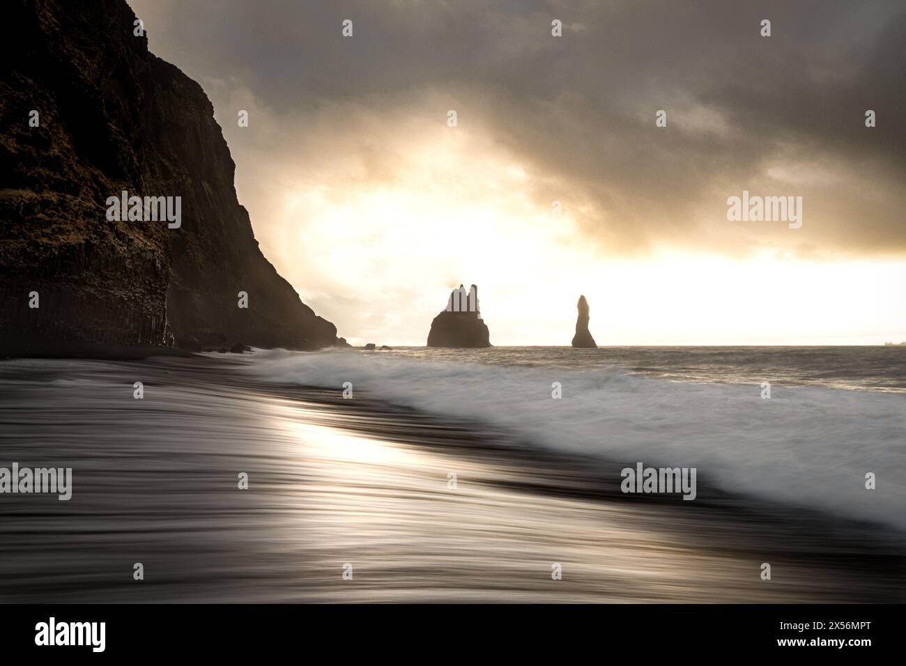Golden sunrise behind Hálsanefshellir sea stacks, waves painting ...