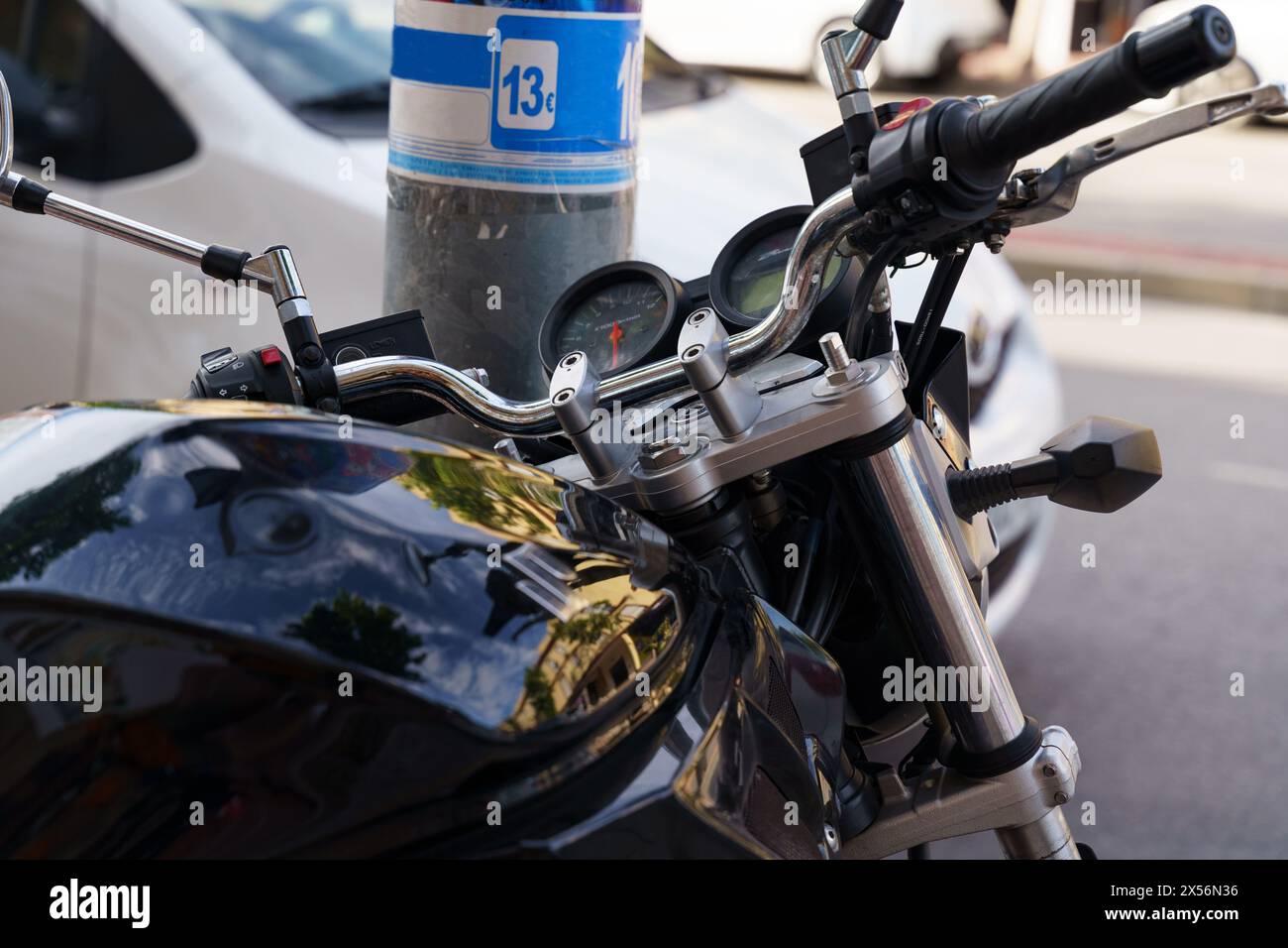A detailed close-up showing a motorcycles handlebars and gauges with a ...