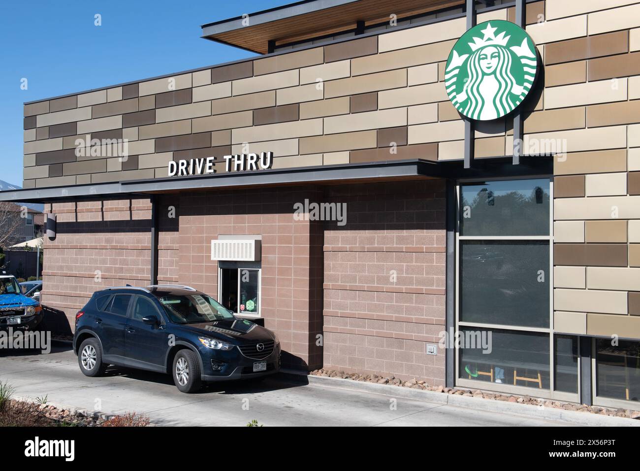 Exteriors of modern Starbucks coffee locations with drive thru windows ...